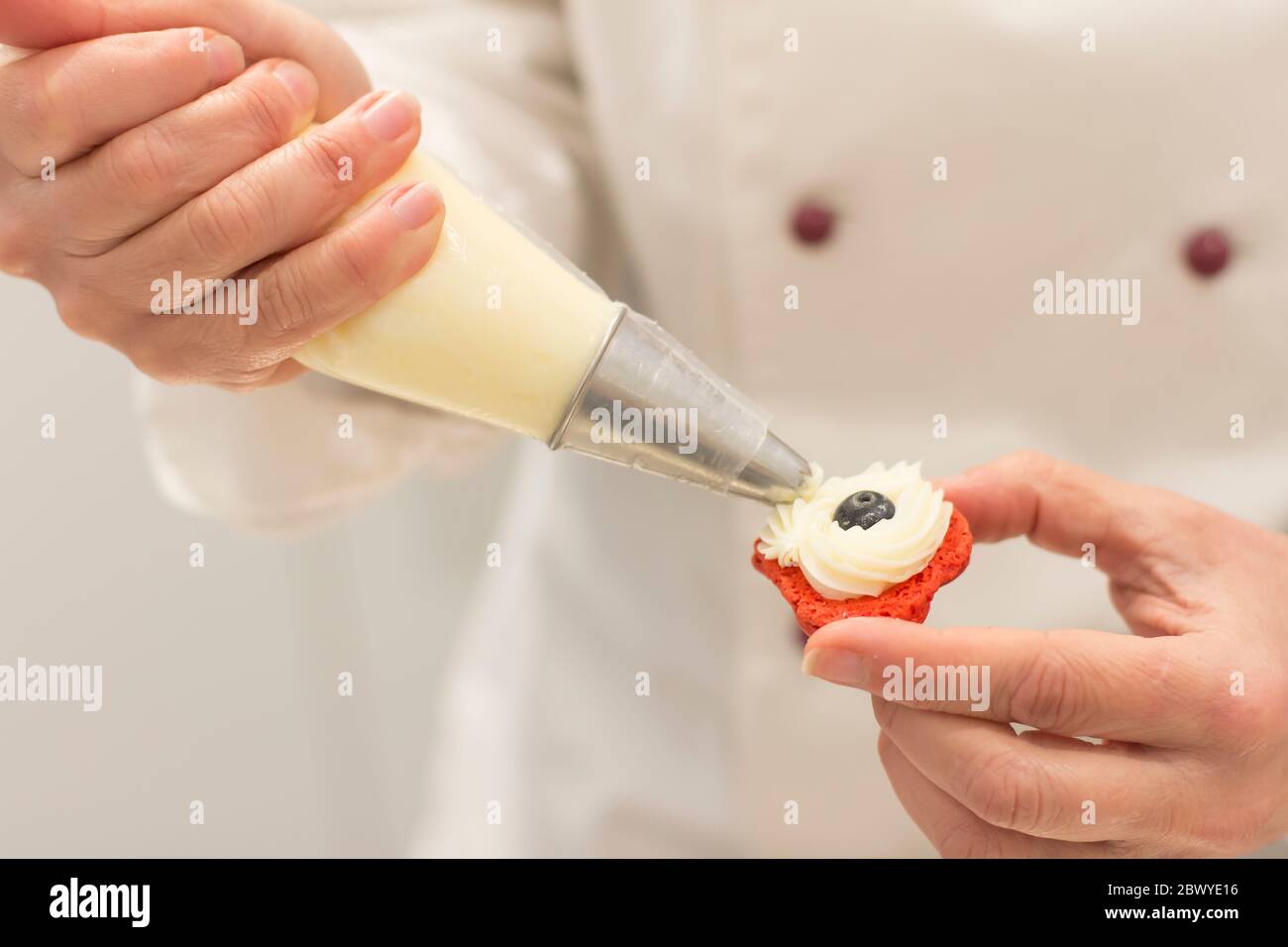Detail of the preparation of macaron, french sweet food, inside a ...