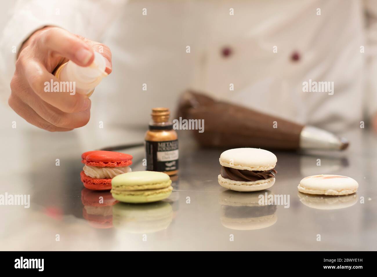 Detail of the preparation of macaron, french sweet food, inside a ...