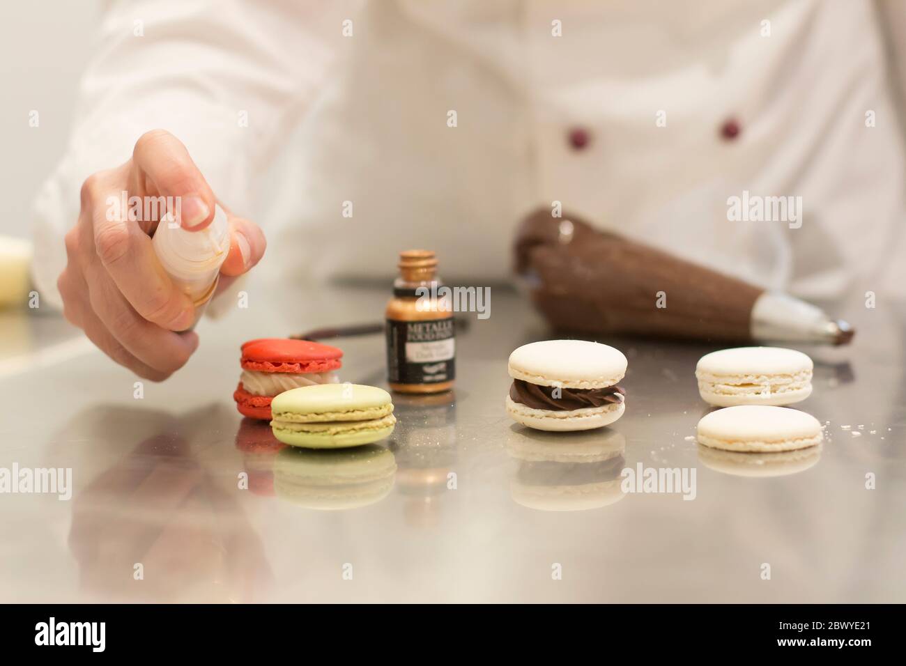 Detail of the preparation of macaron, french sweet food, inside a ...