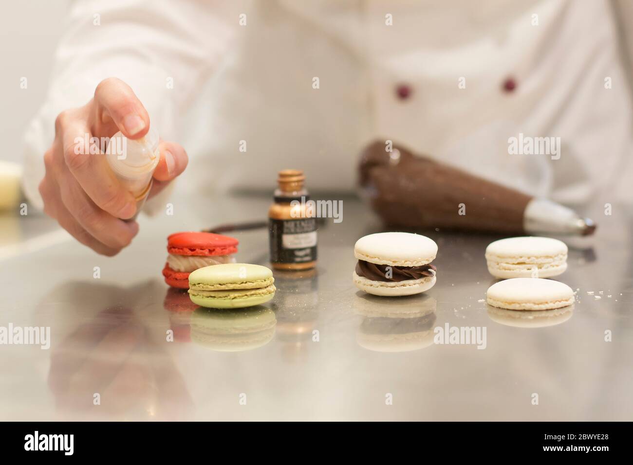 Detail of the preparation of macaron, french sweet food, inside a ...
