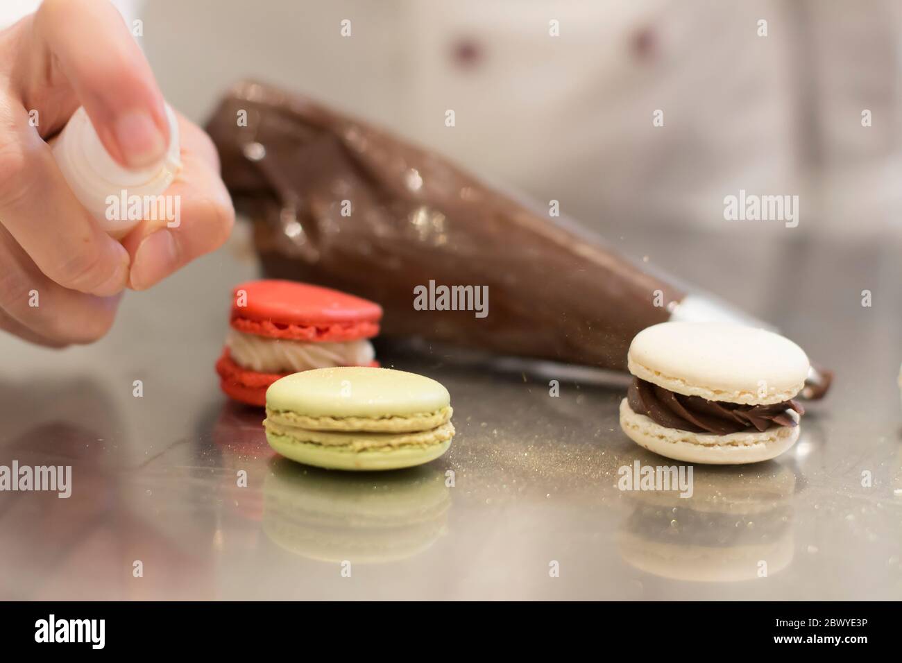 Detail of the preparation of macaron, french sweet food, inside a ...