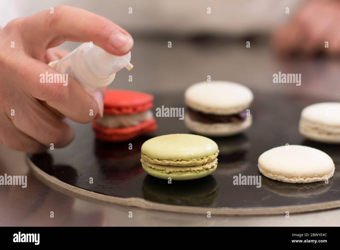 Detail of the preparation of macaron, french sweet food, inside a ...