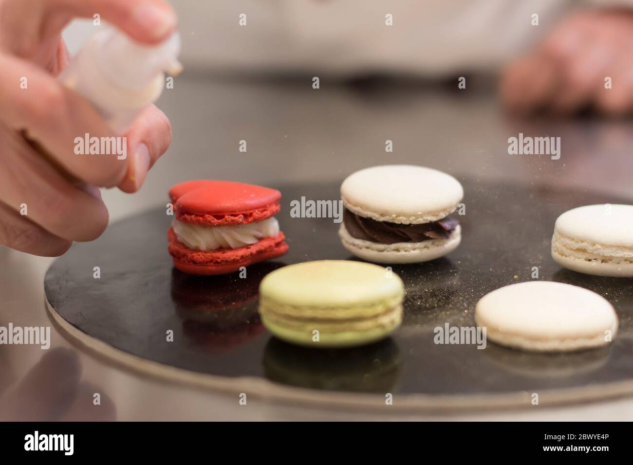 Detail of the preparation of macaron, french sweet food, inside a ...