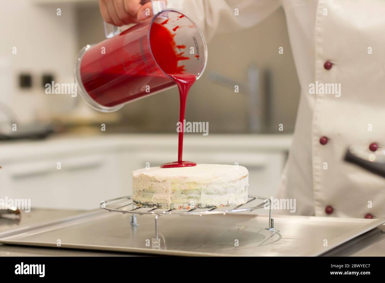 Close up on the preparation of a strawberry cheesecake inside a ...