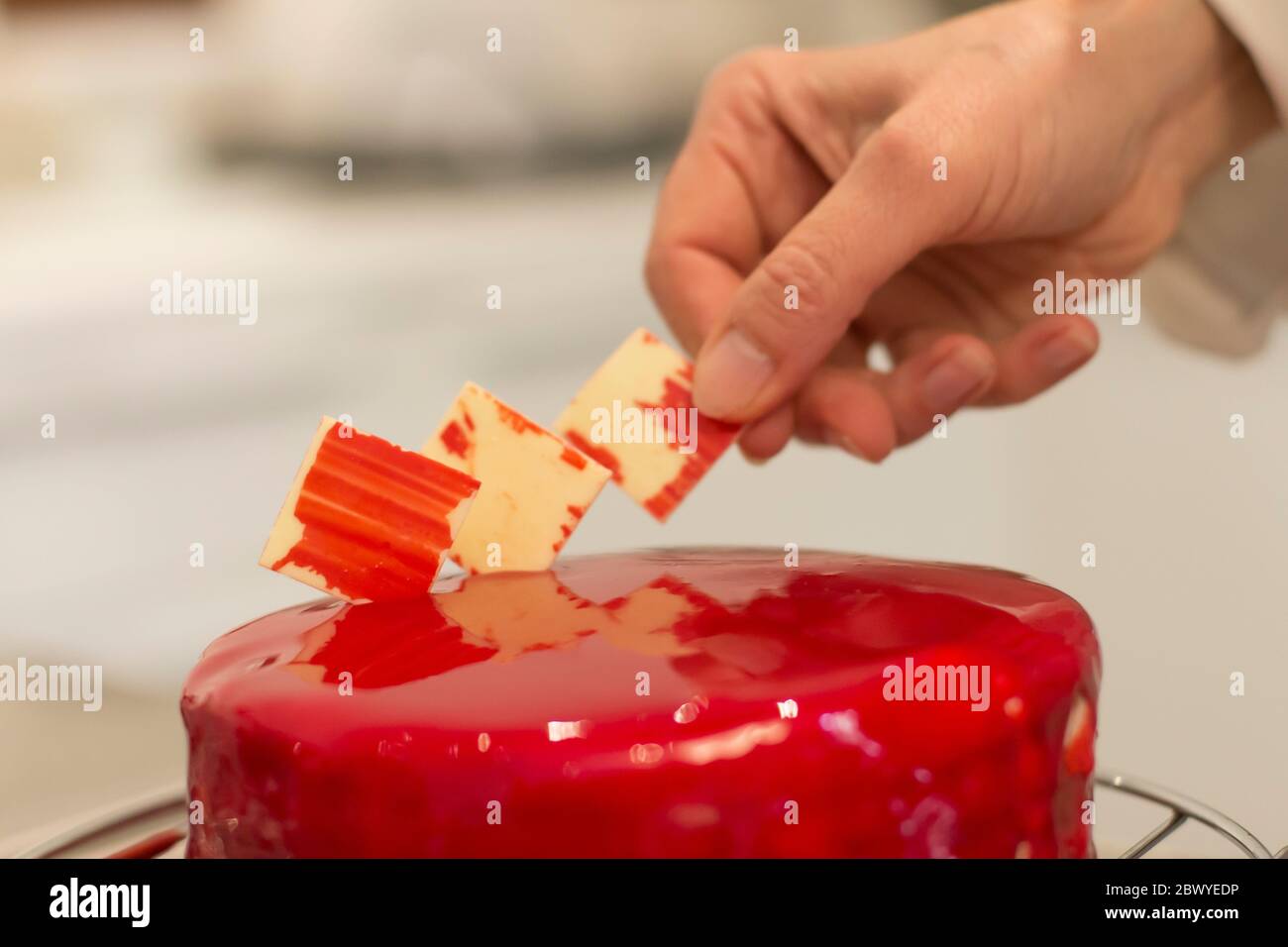 Close up on the preparation of a strawberry cheesecake inside a ...