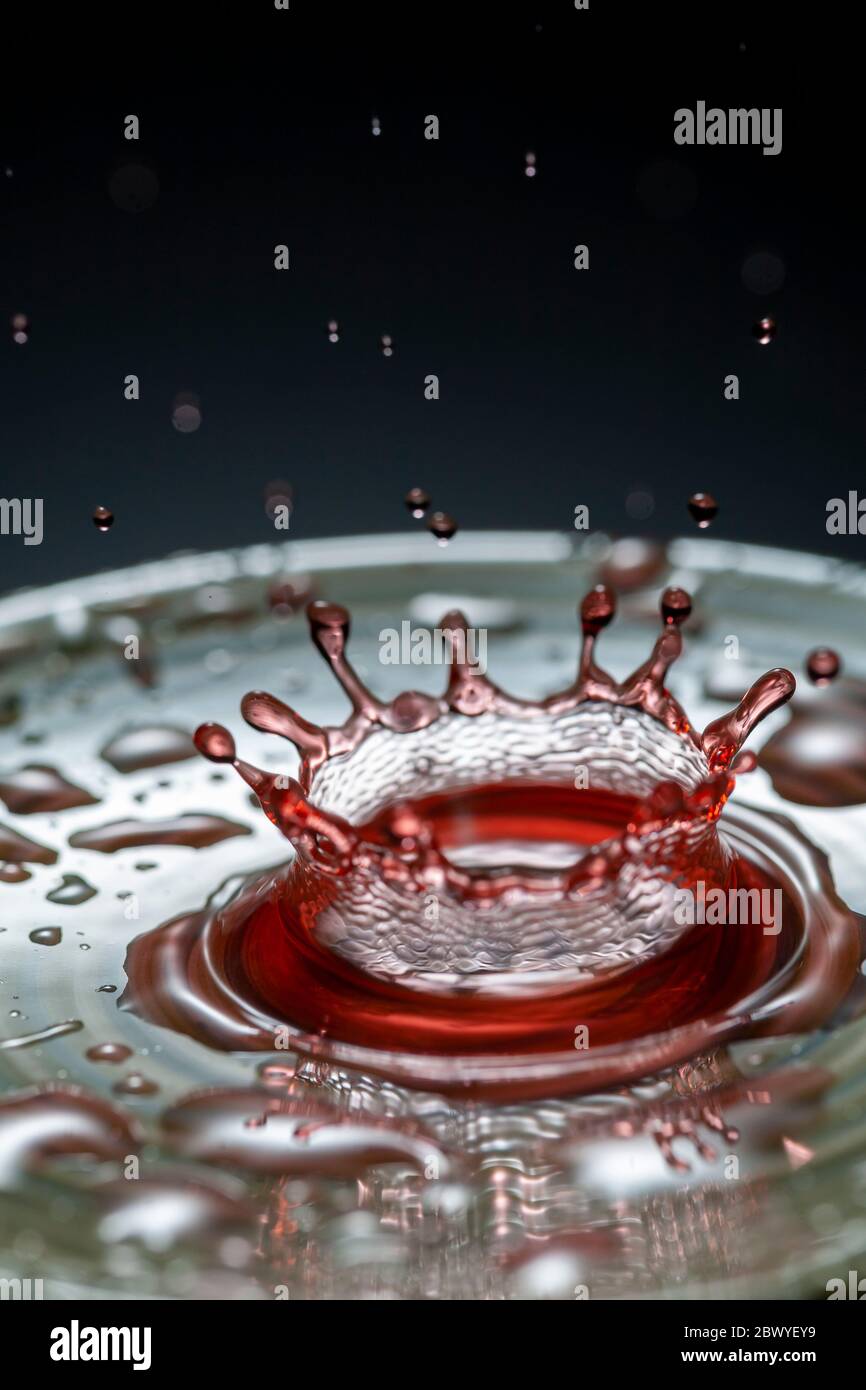 Red water drop splashing - high speed photo Stock Photo - Alamy