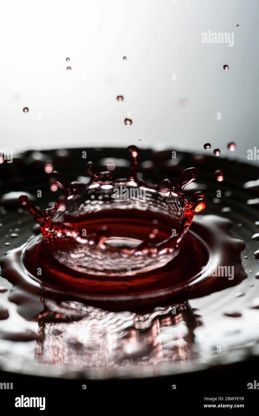 Red water drop splashing - high speed photo Stock Photo - Alamy