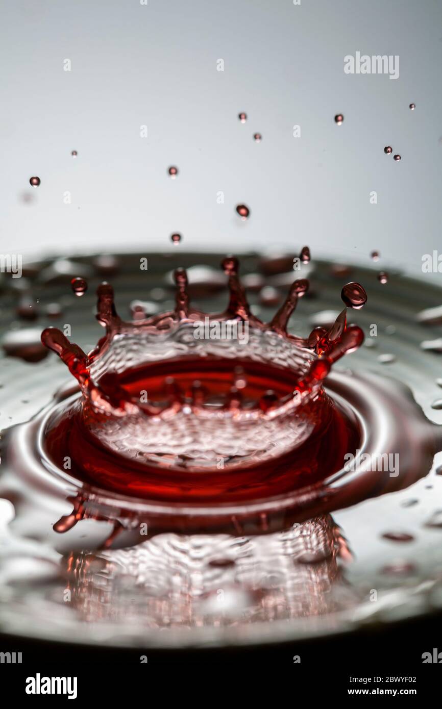 Red water drop splashing - high speed photo Stock Photo - Alamy