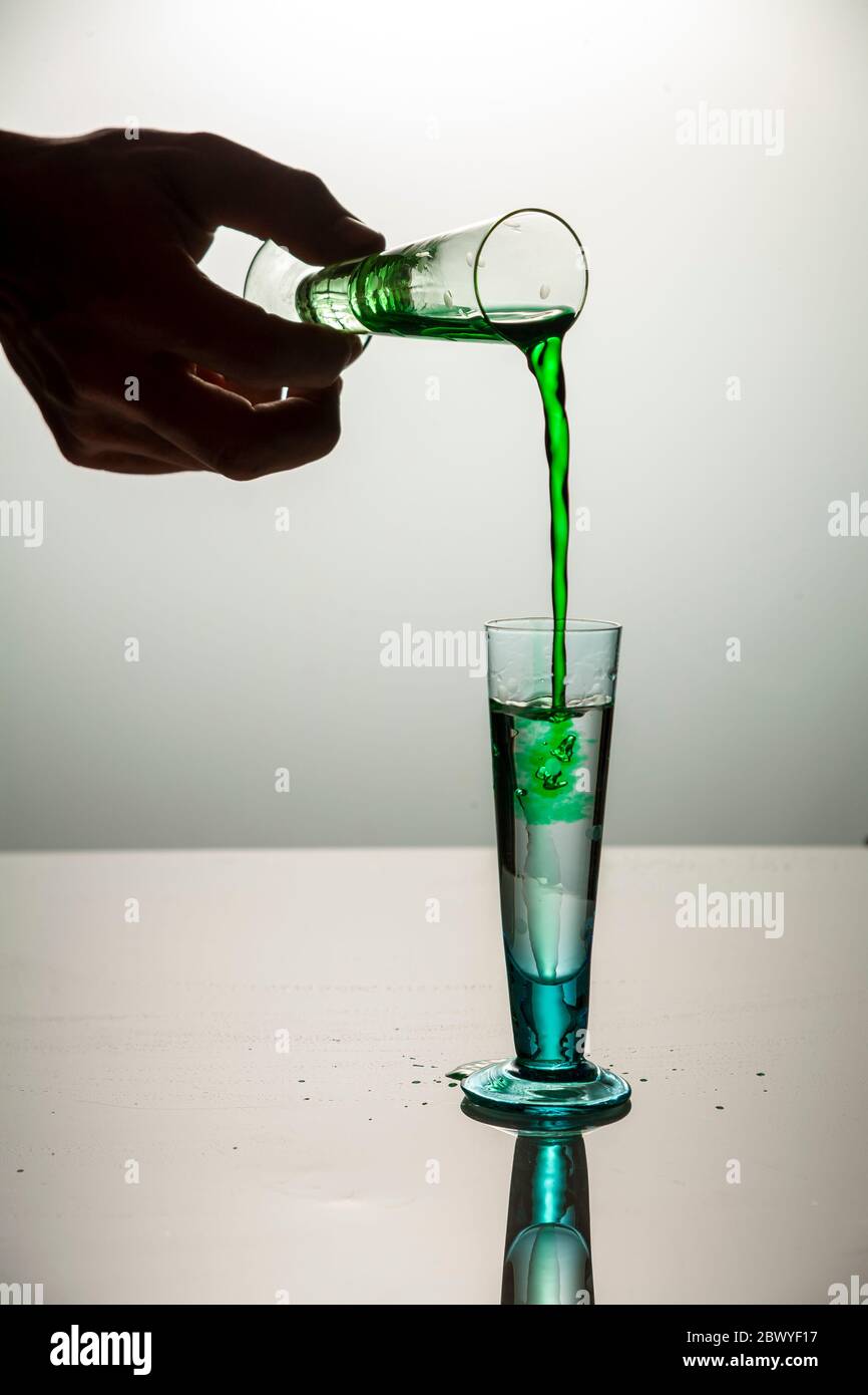 Pouring different color liquids into glasses Stock Photo - Alamy