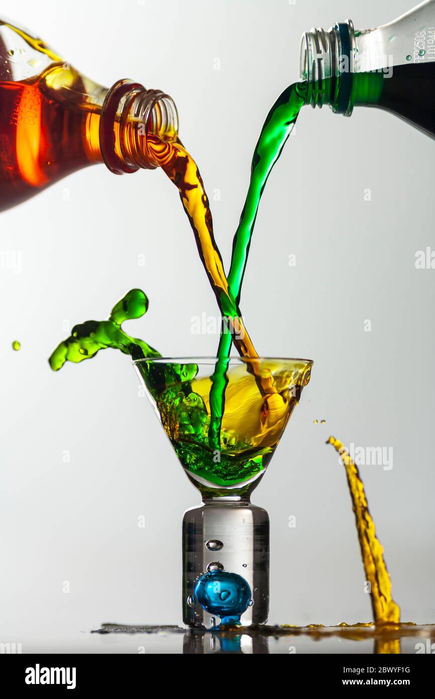 Pouring different color liquids into glasses Stock Photo - Alamy