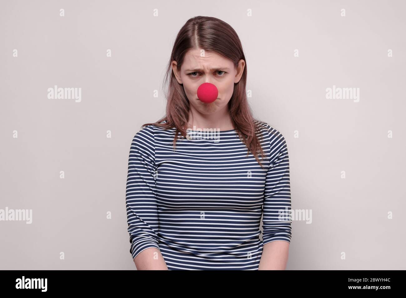 Beautiful woman with red nose looking angry and frustrated being ...