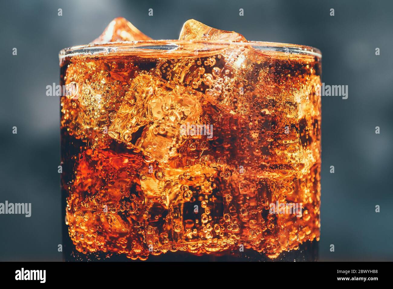 Cola soda drink in glass with ice cubes and bubbles, macro photo, vintage toned Stock Photo - Alamy