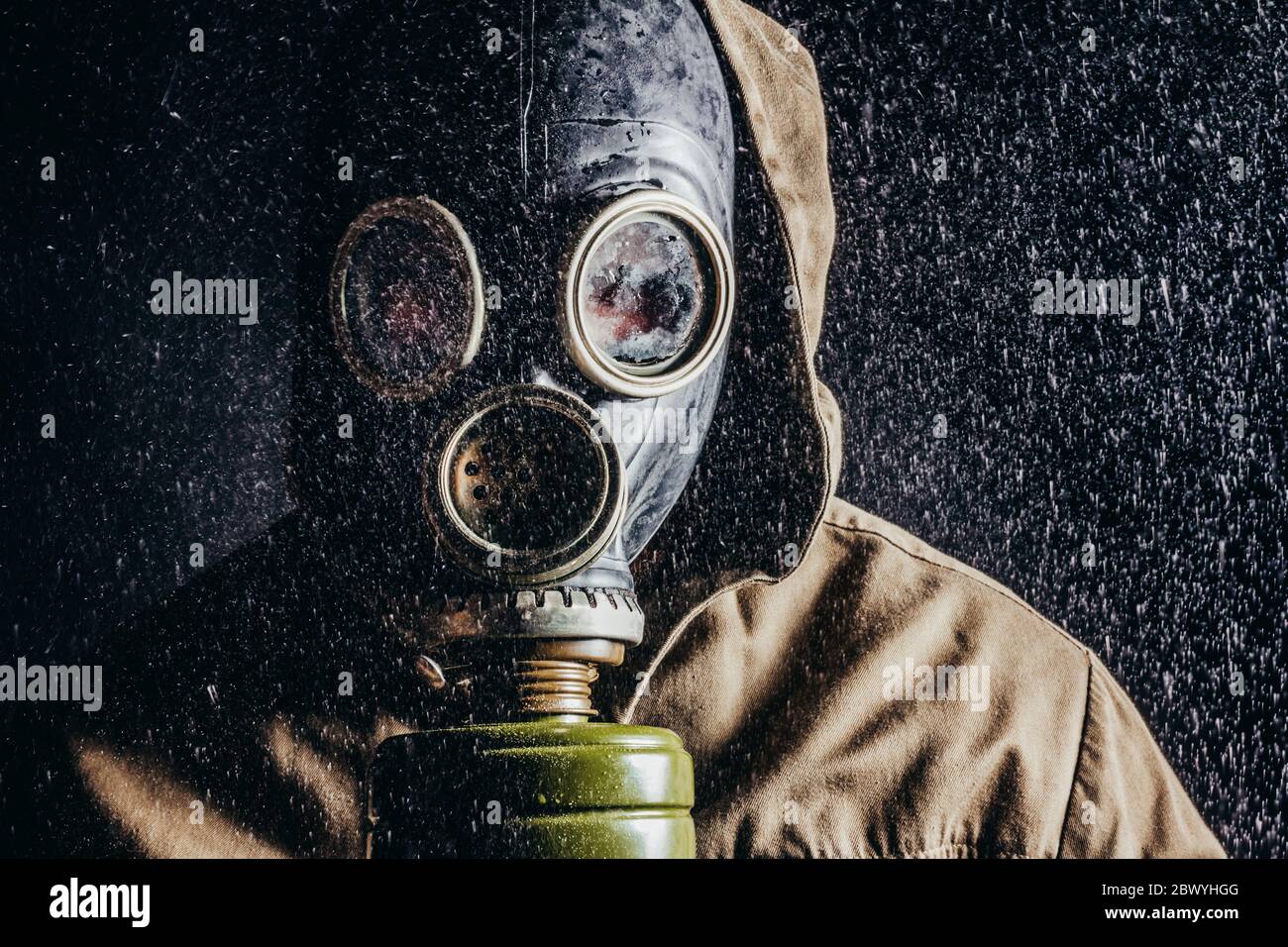 Photo of a stalker face in soviet gas mask in rain on black background ...