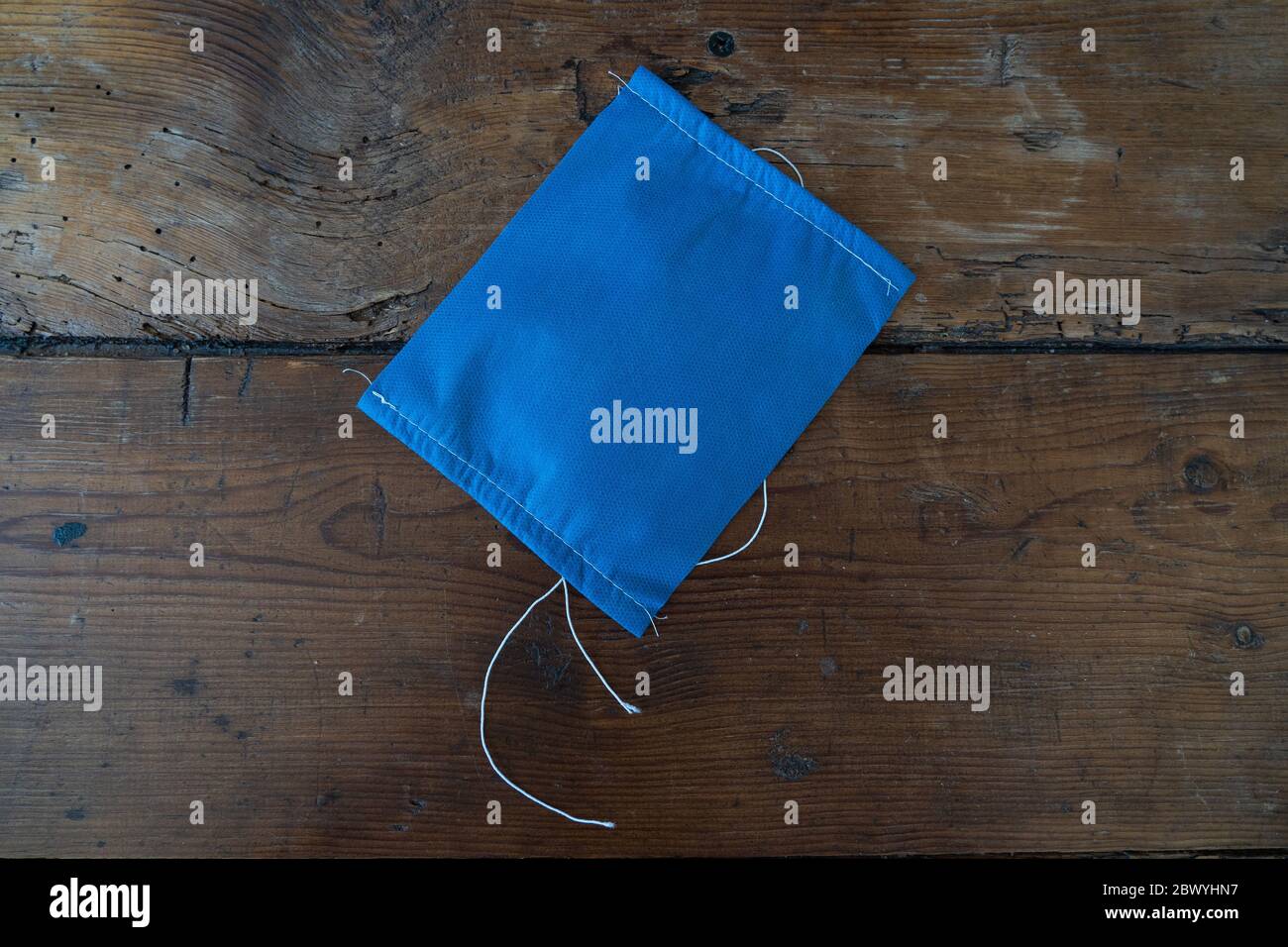 Blue face mask, ready to be worn, on table Stock Photo - Alamy