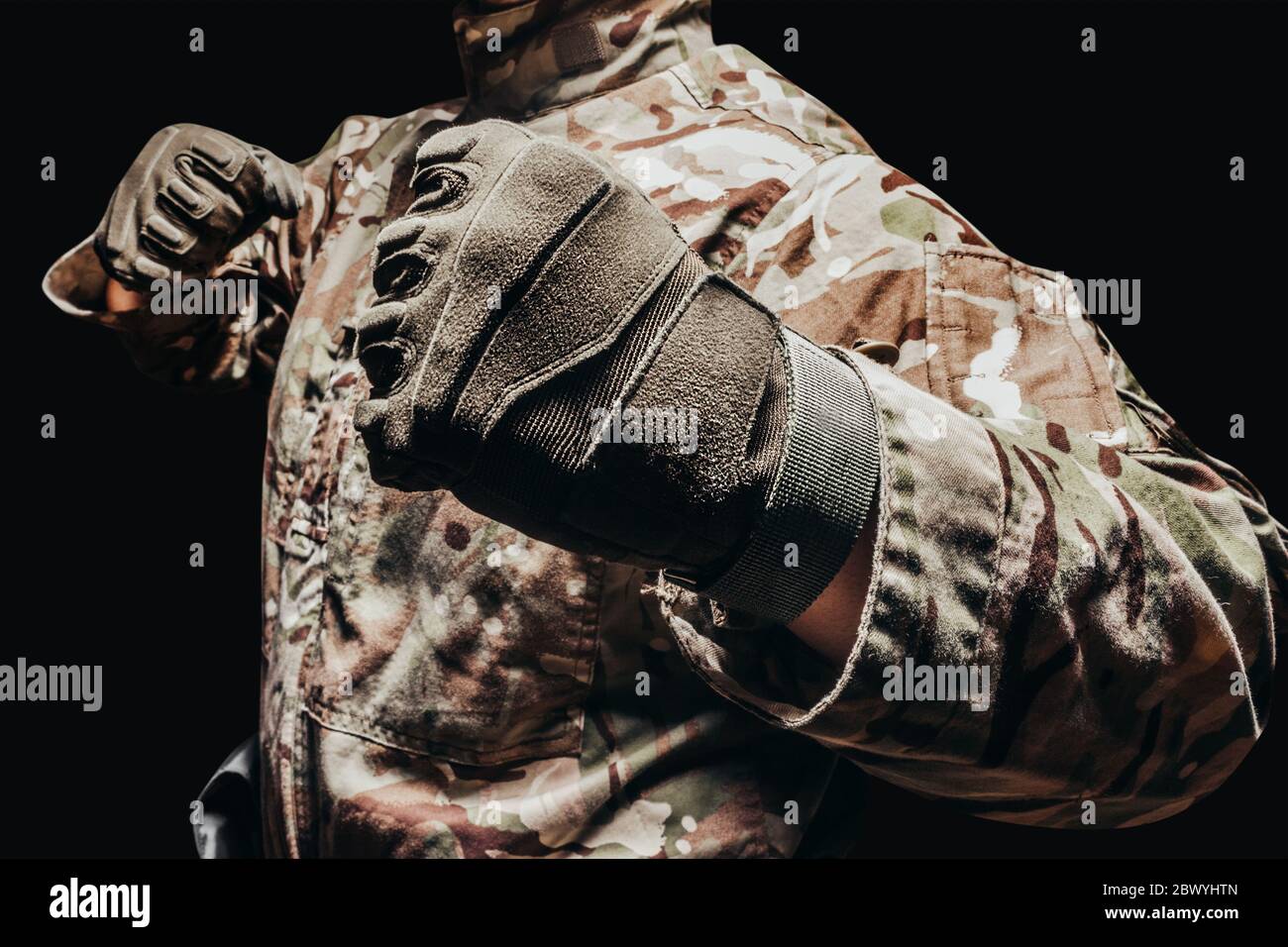Photo of a soldier in multicam camouflage tunic in punching pose on ...