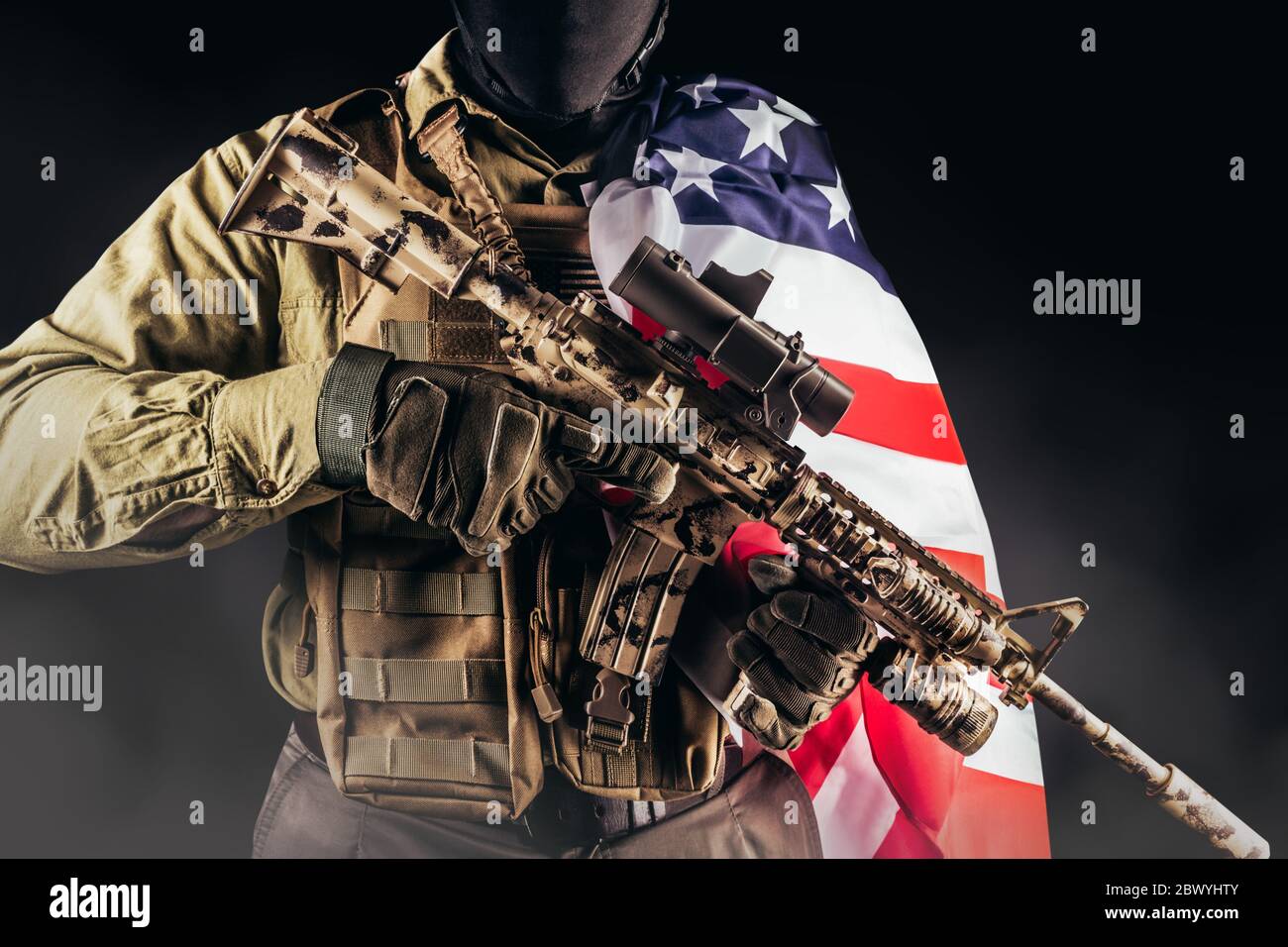 Photo of a fully equipped soldier in armor vest and rifle standing with ...