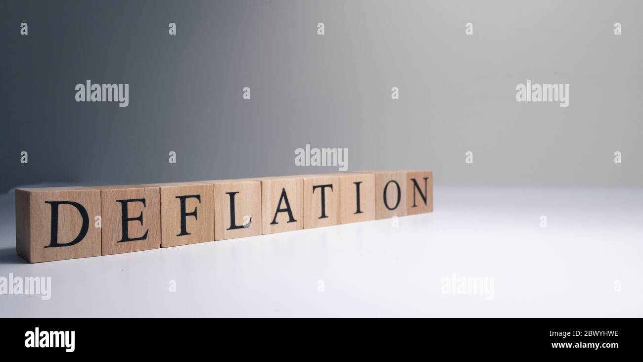 Deflation text from wooden cubes. Spot light in the studio and white ...