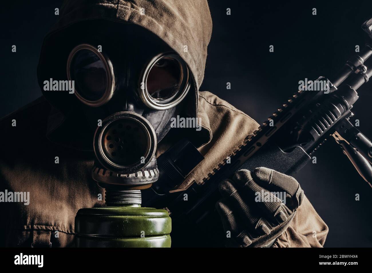 Photo of a stalker man in soviet gas mask holding sniper rifle closeup ...