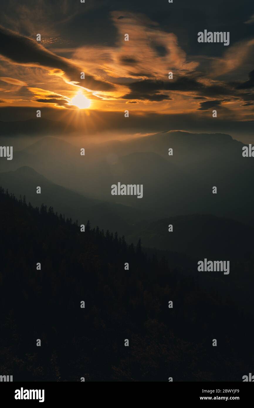 mountain peak with fog during sunrise in austria Stock Photo - Alamy