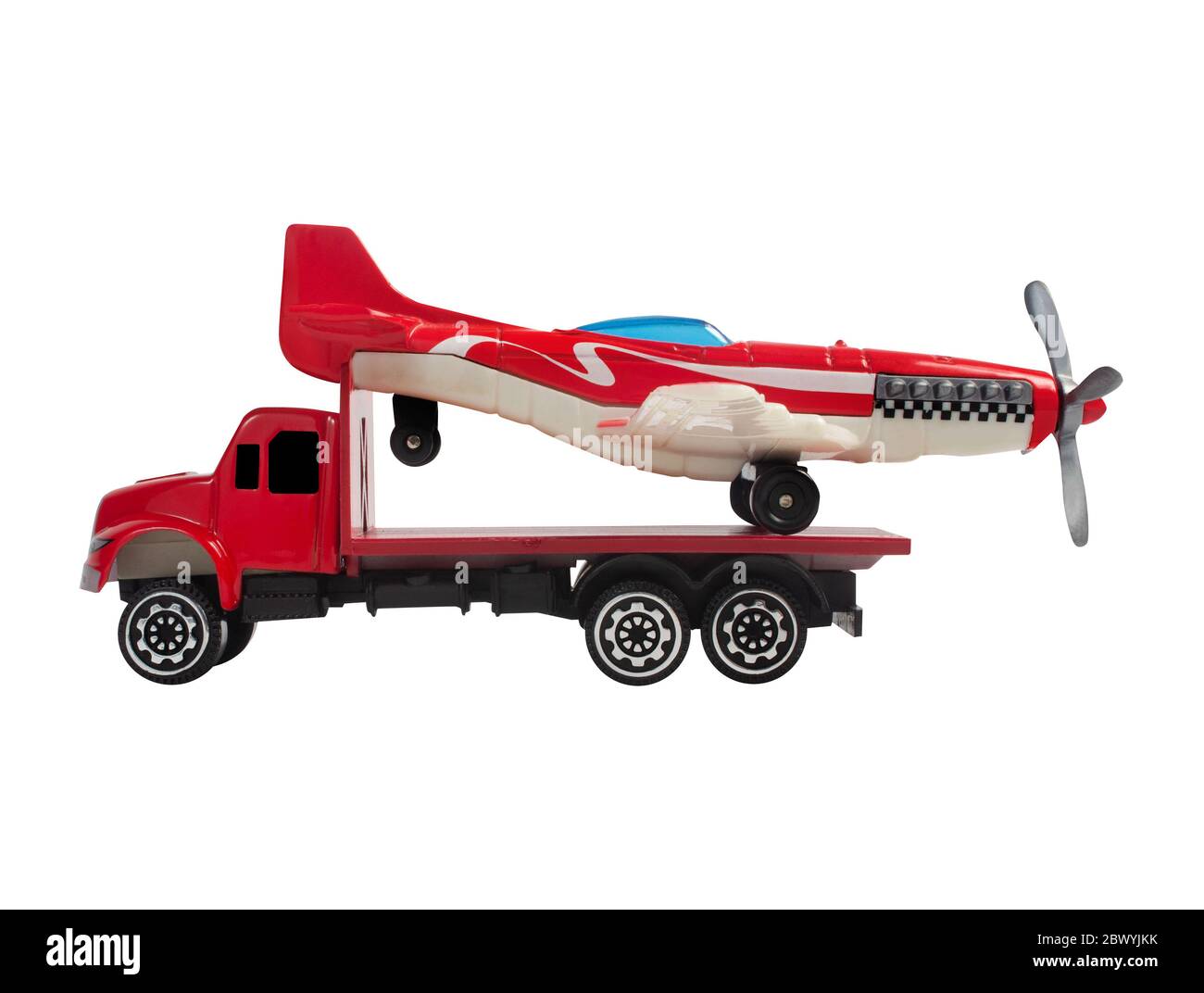 Isolated photo of a toy truck carrying miniature airplane side view ...