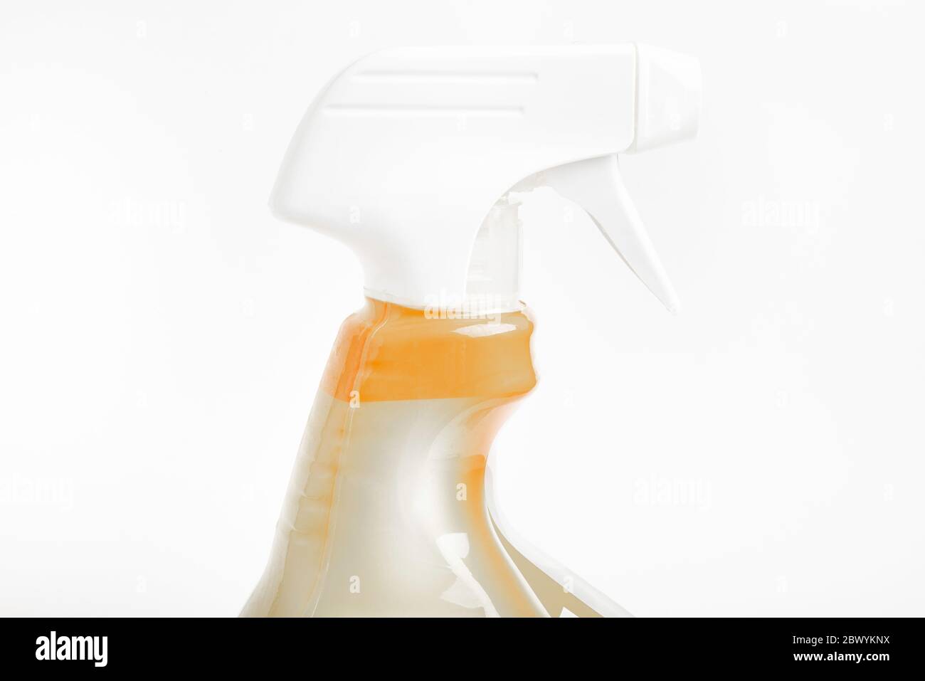 A close-up of the top portion of an orange and white liquid spray ...