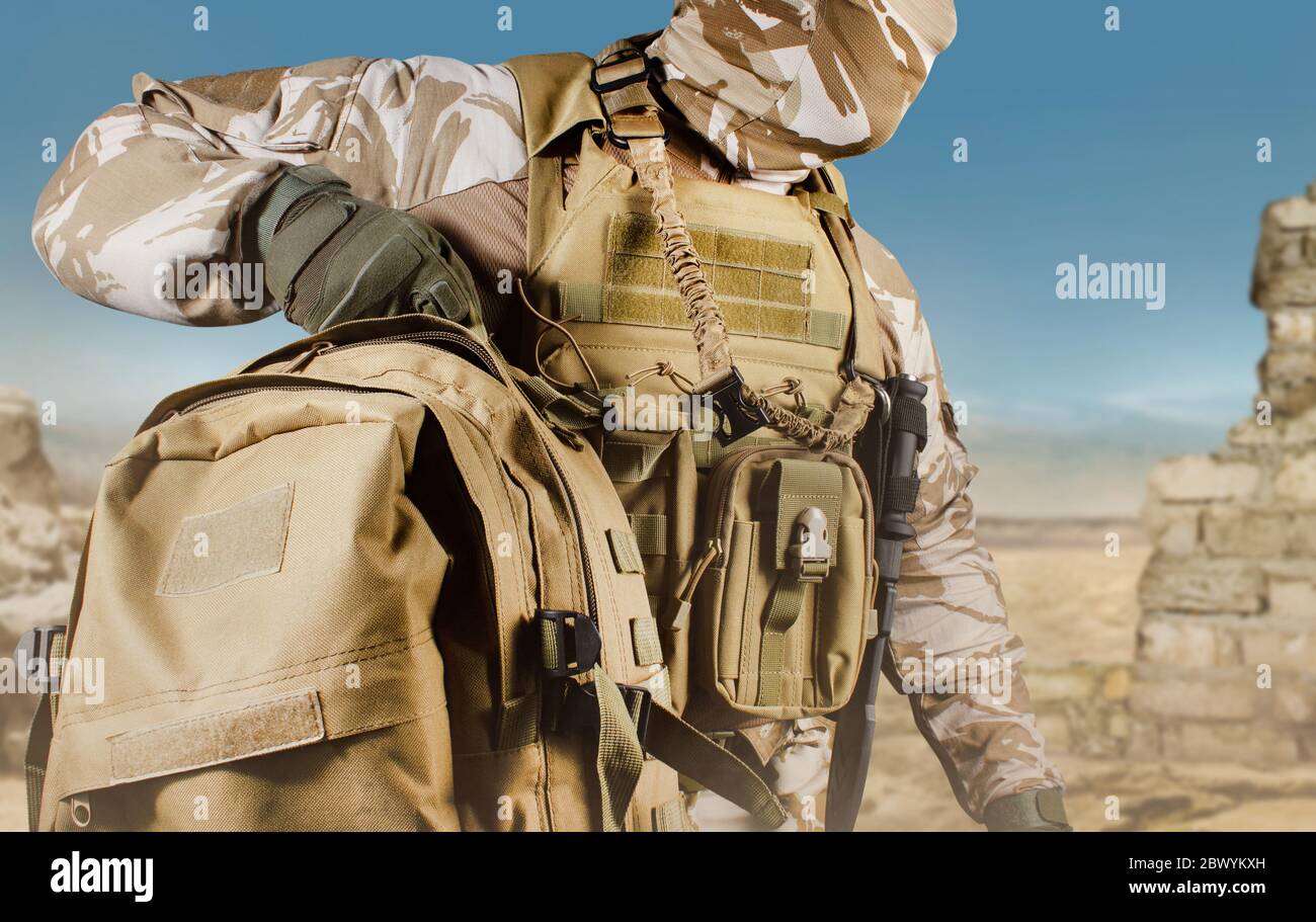 Photo of a fully equipped soldier in uniform, armor and mask walking ...
