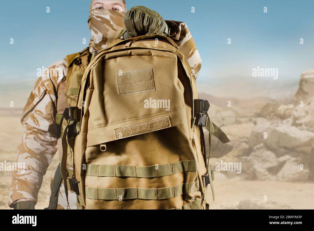 Photo of a fully equipped soldier in uniform, armor and mask holding ...
