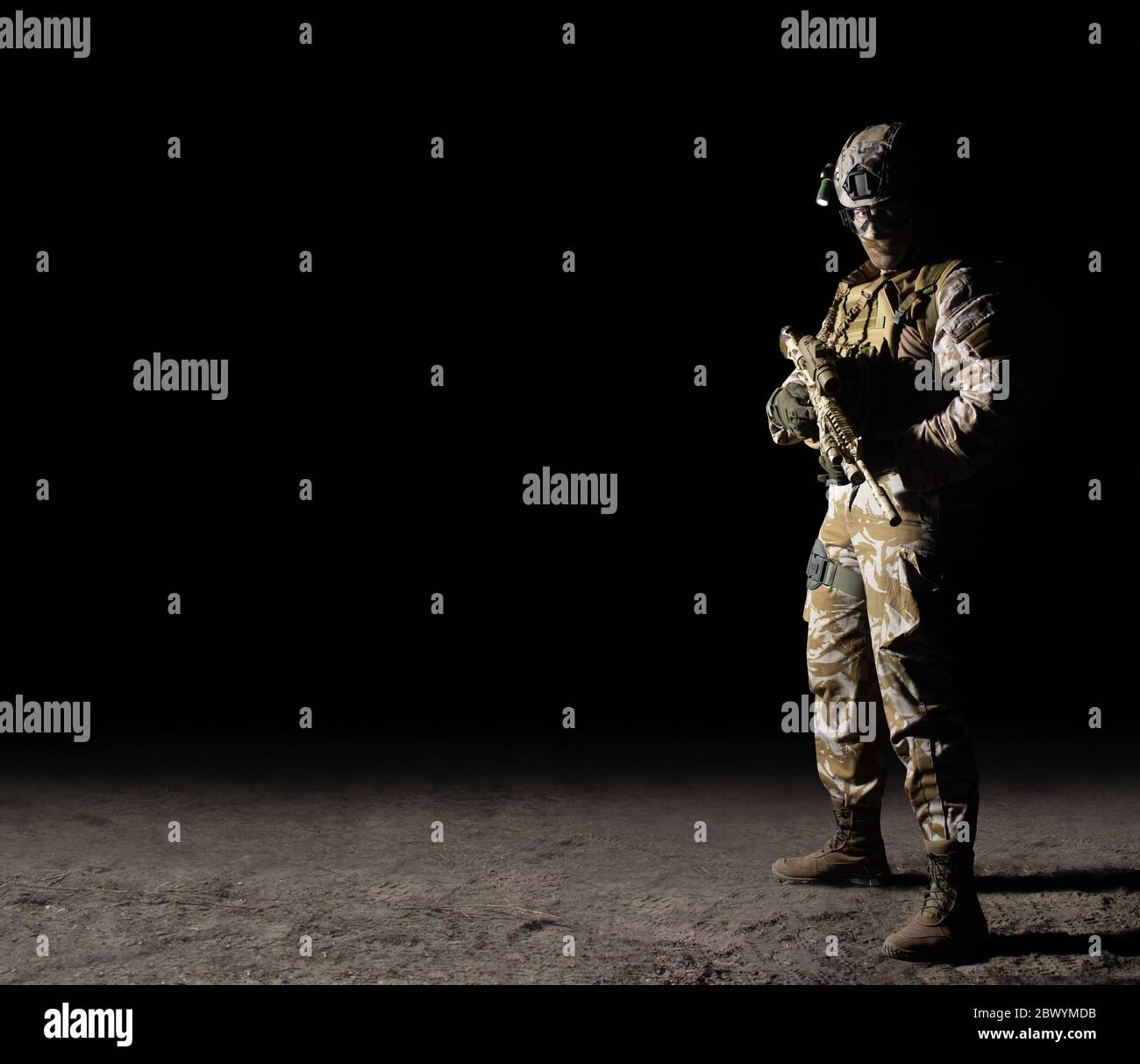 Photo of a fully equipped soldier standing with automatic rifle with ...