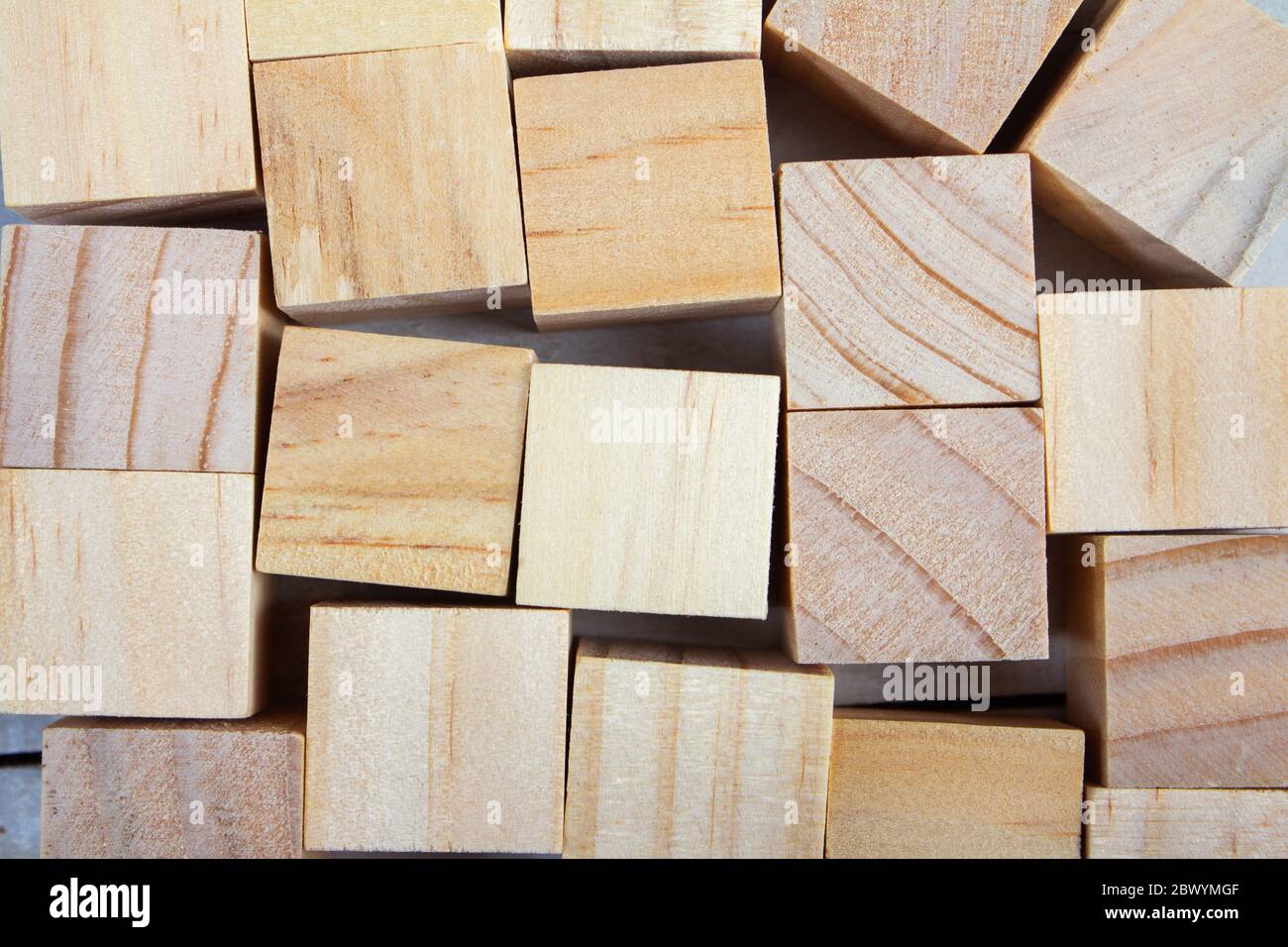 Photo of a pile of different textured wooden cubes laying on table ...