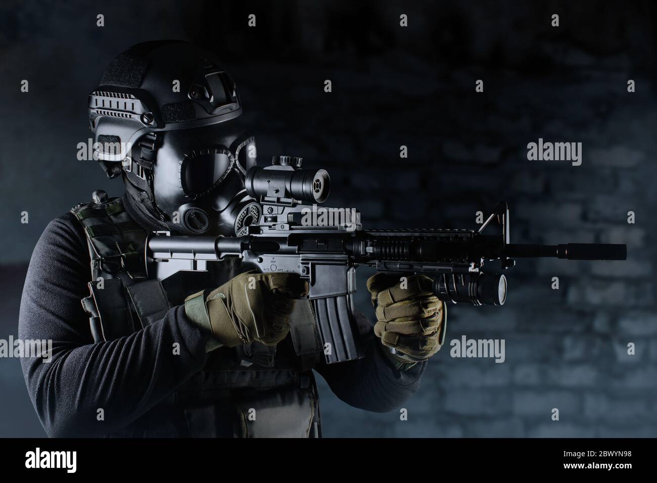 Photo of a fully equipped soldier in black armor tactical vest, gas ...