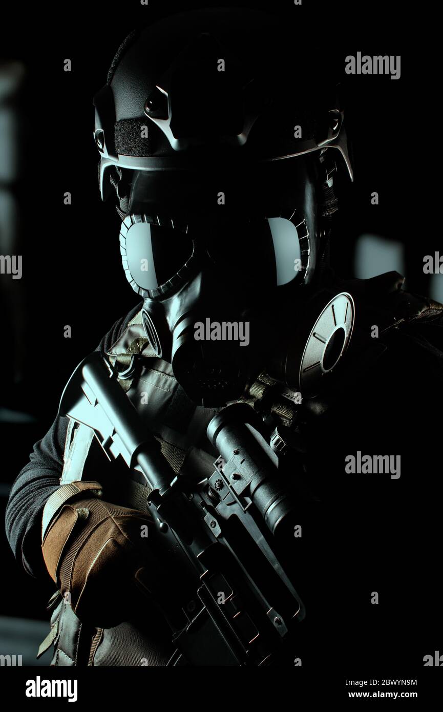 Photo of a fully equipped soldier in black armor tactical vest, gas ...