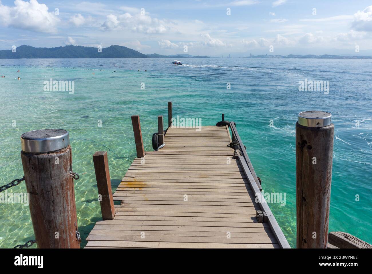Beautiful wooden jetty with clear blue sky and clear blue sea water ...