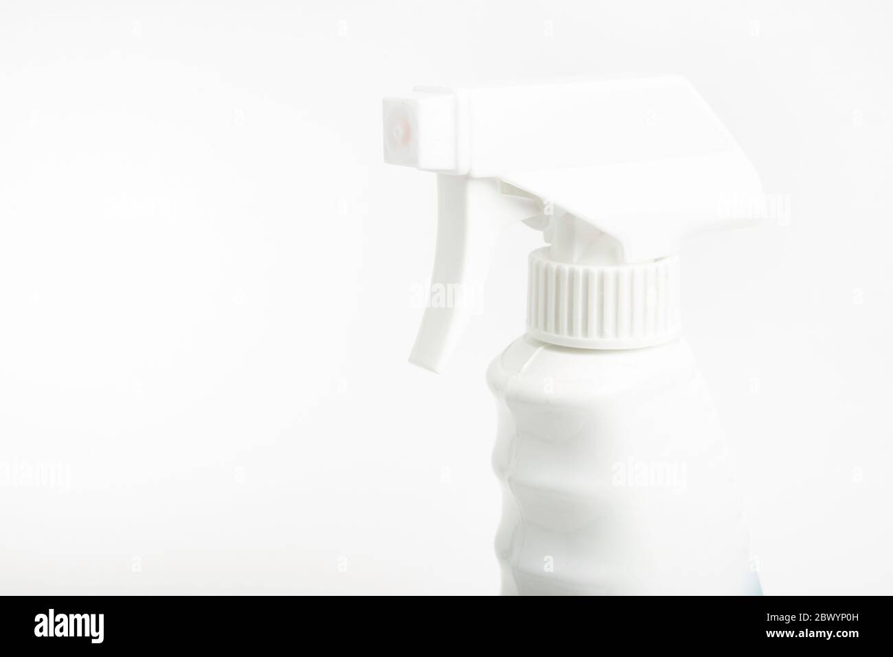 A close-up of the top portion of an all-white liquid spray plastic ...