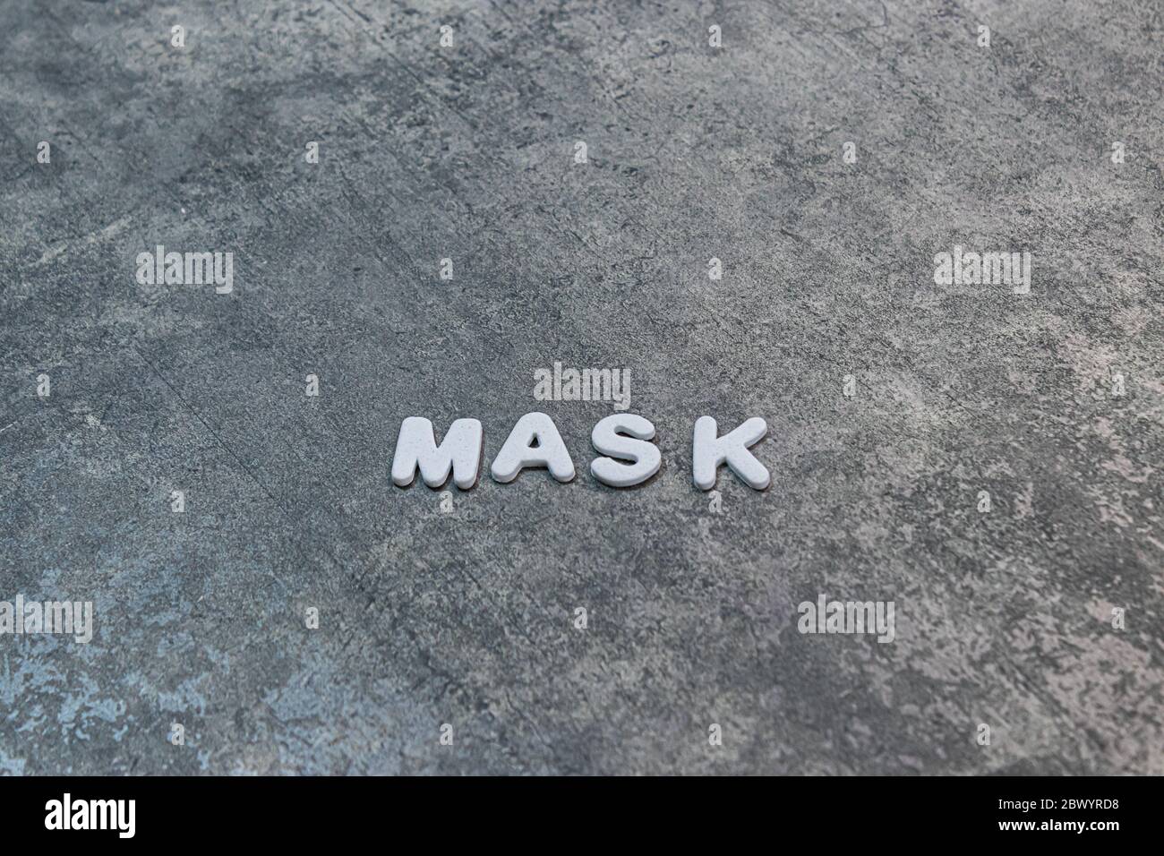 mask written out on gray background with white lettering Stock Photo ...