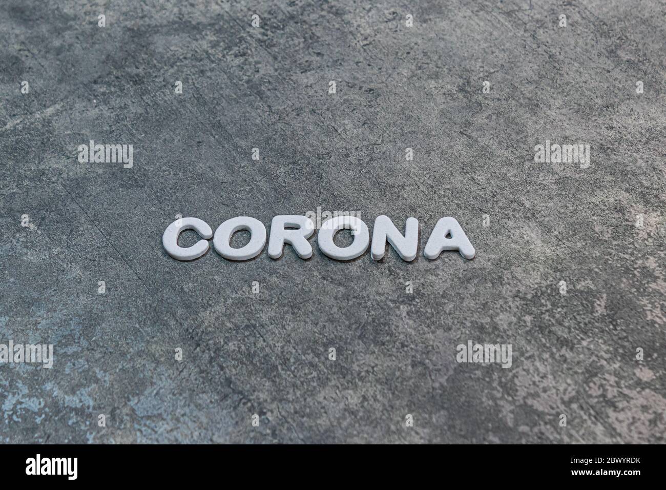 corona written out on gray background with white lettering centered ...