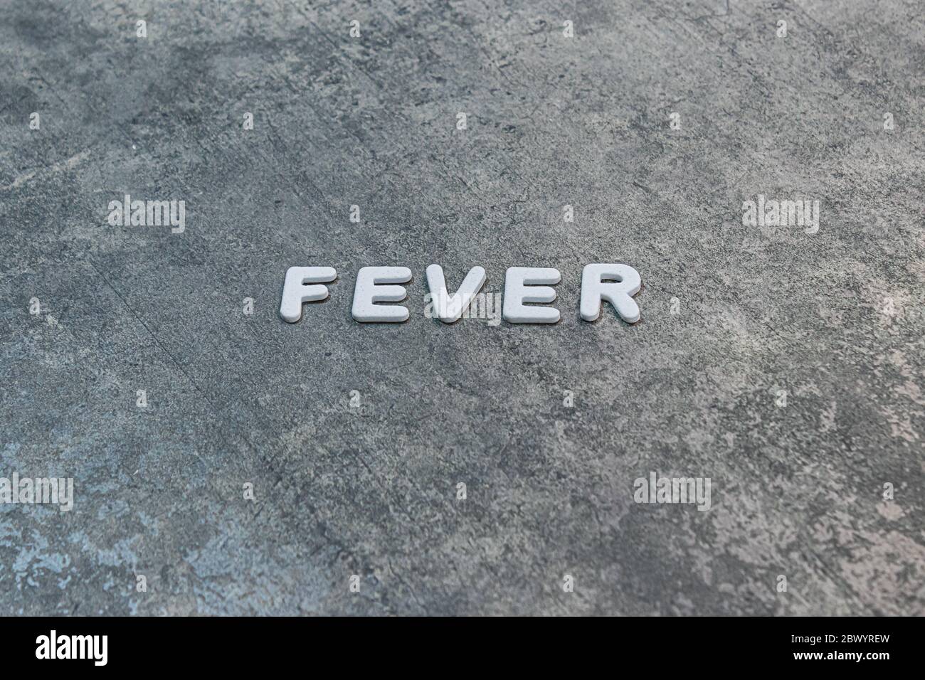 fever written out on gray background with white lettering centered ...
