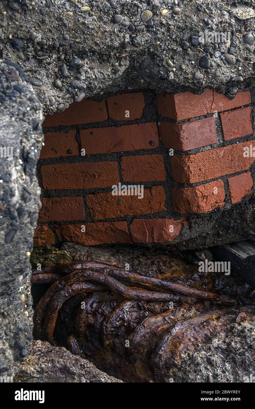 Urban decay. Metal, stone, bricks and wood turning into organic ...