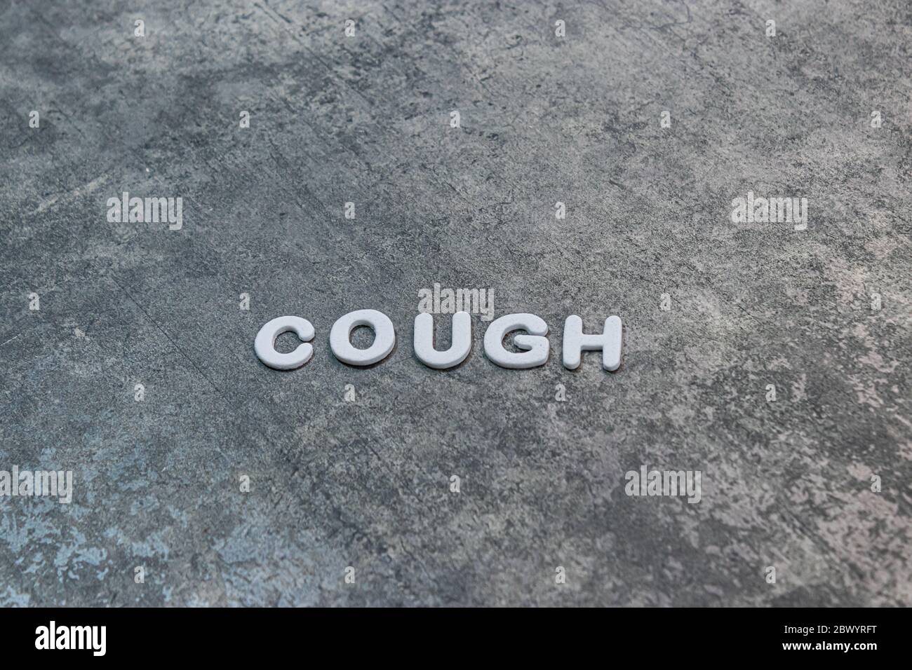 cough written out on gray background with white lettering centered ...