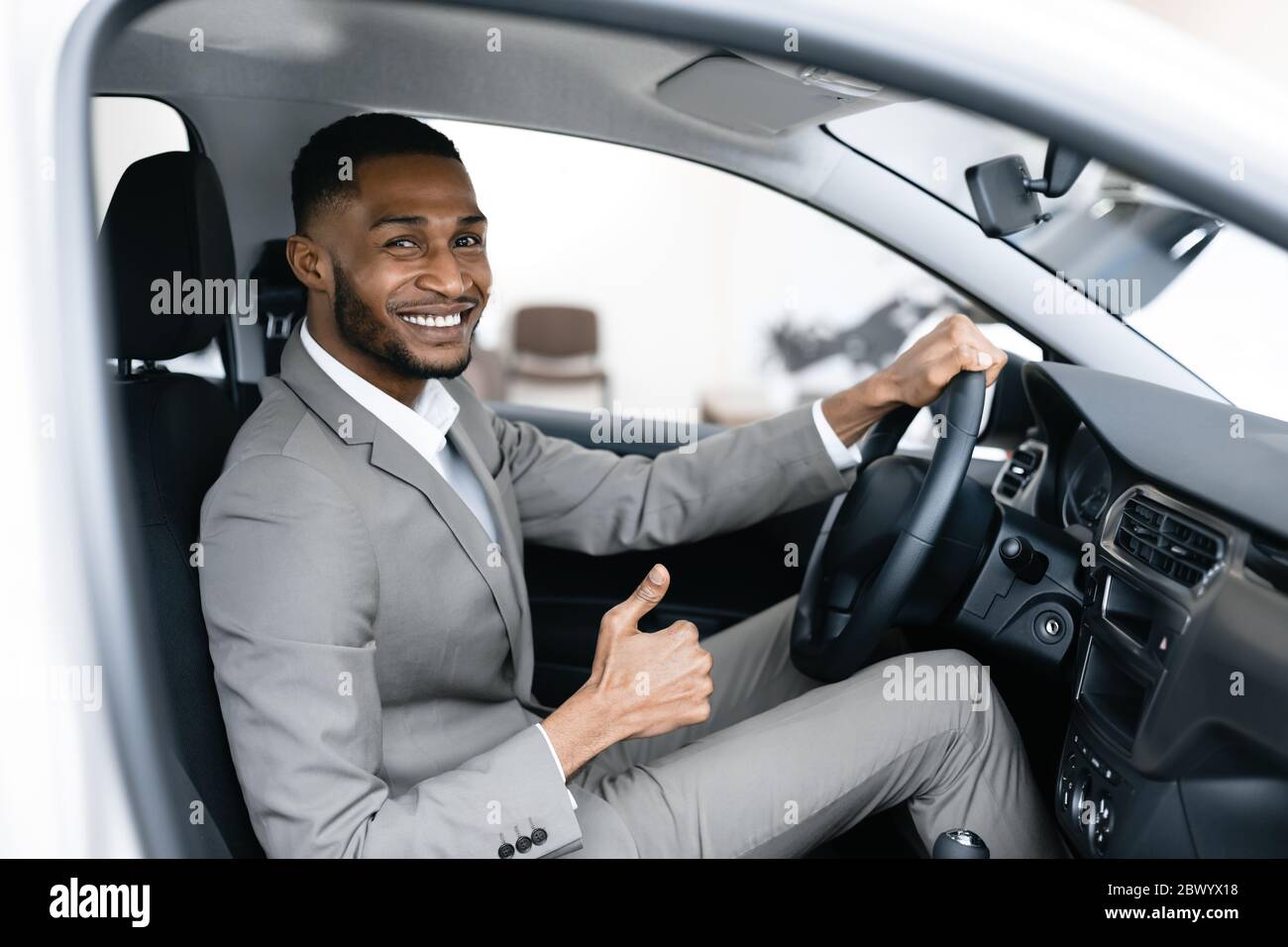 African Businessman Gesturing Thumbs Up Sitting In Driver's Seat Stock ...