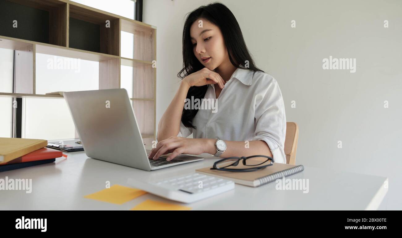 Asian businesswoman working with portable laptop computer Stock Photo ...