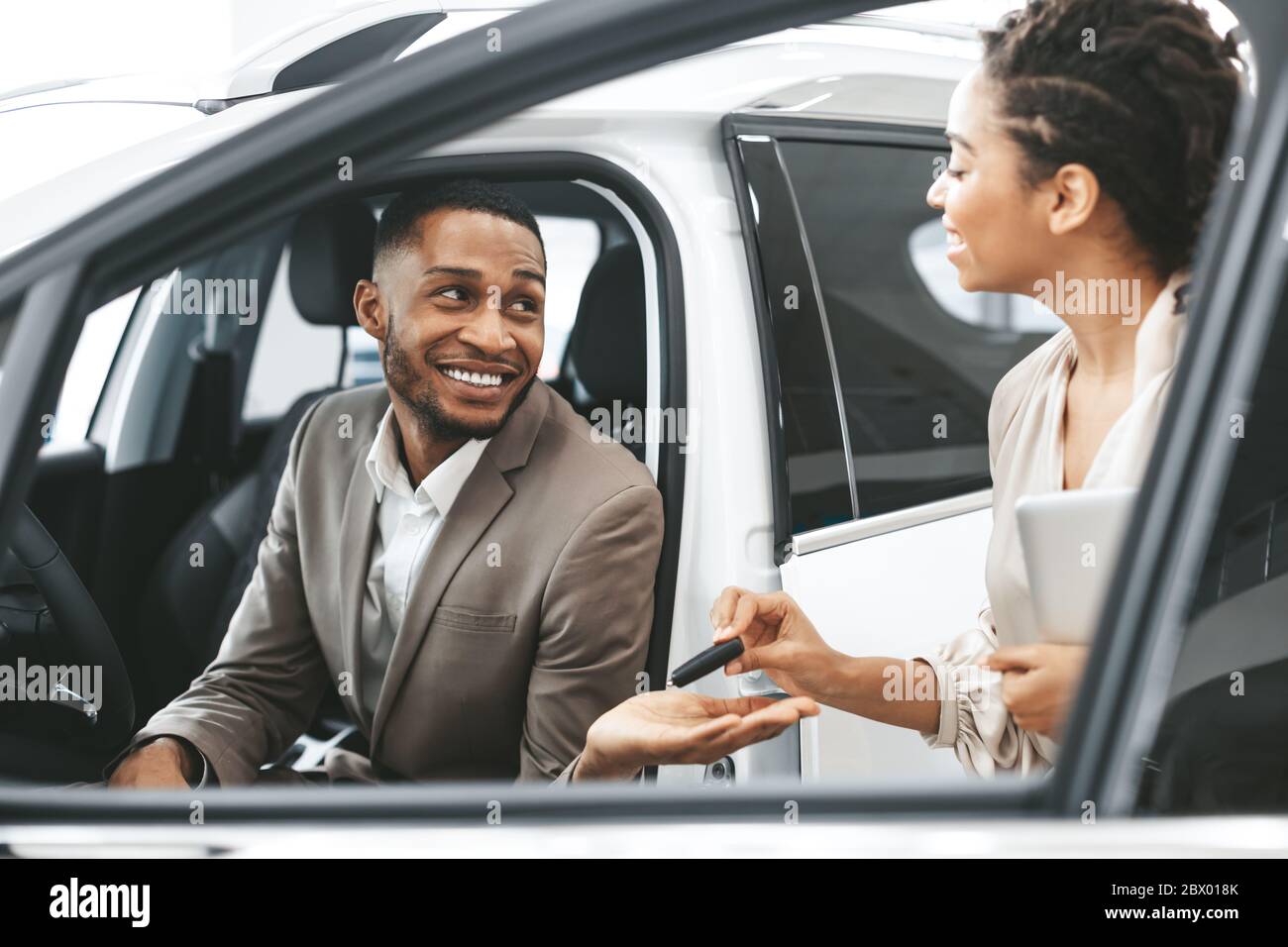 Businessman Taking Key From Dealer For Test Drive In Dealership Stock ...
