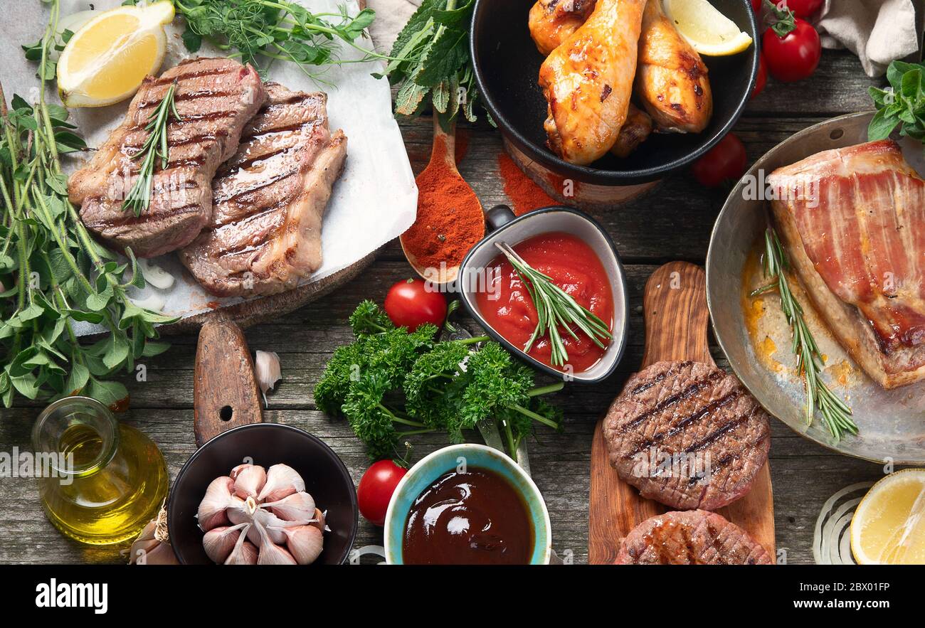 Different types of Grilled meat on rustic wooden table. Top view Stock ...