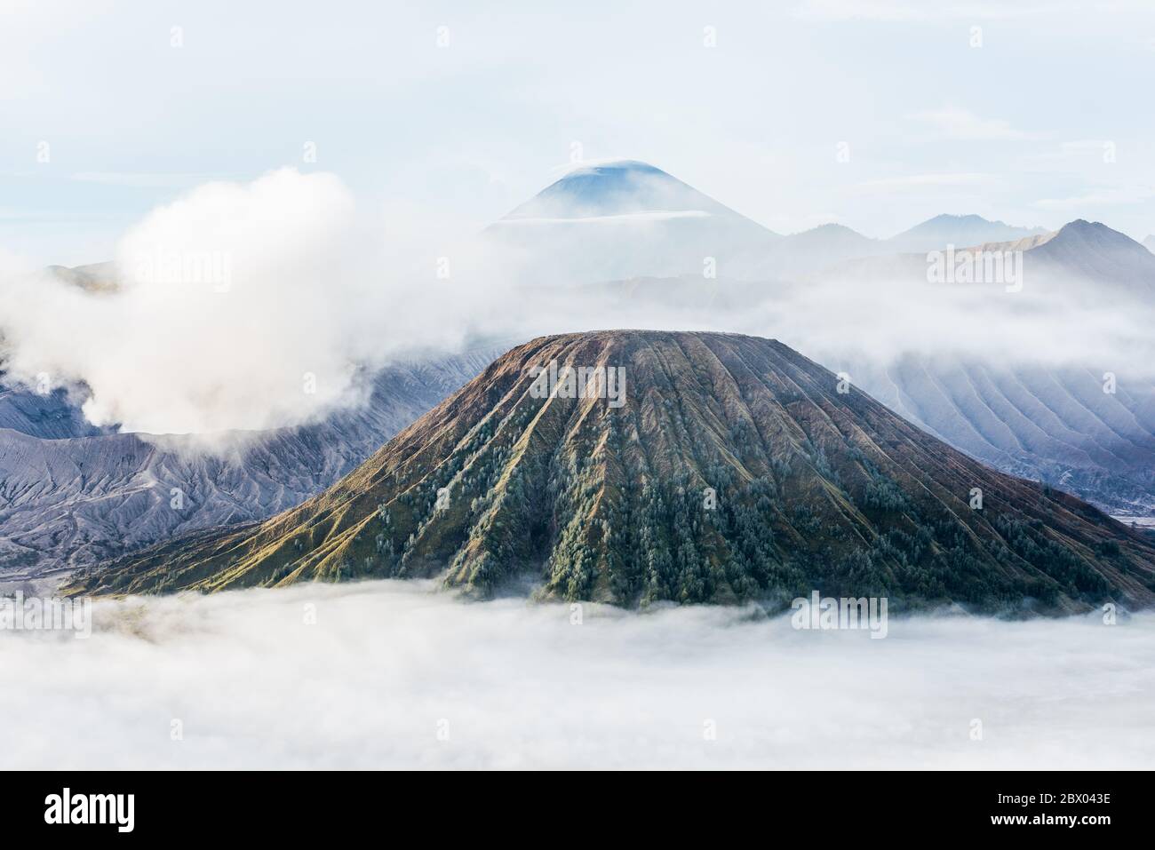 view of Mount Bromo under cloudy sky with the sand sea Stock Photo - Alamy