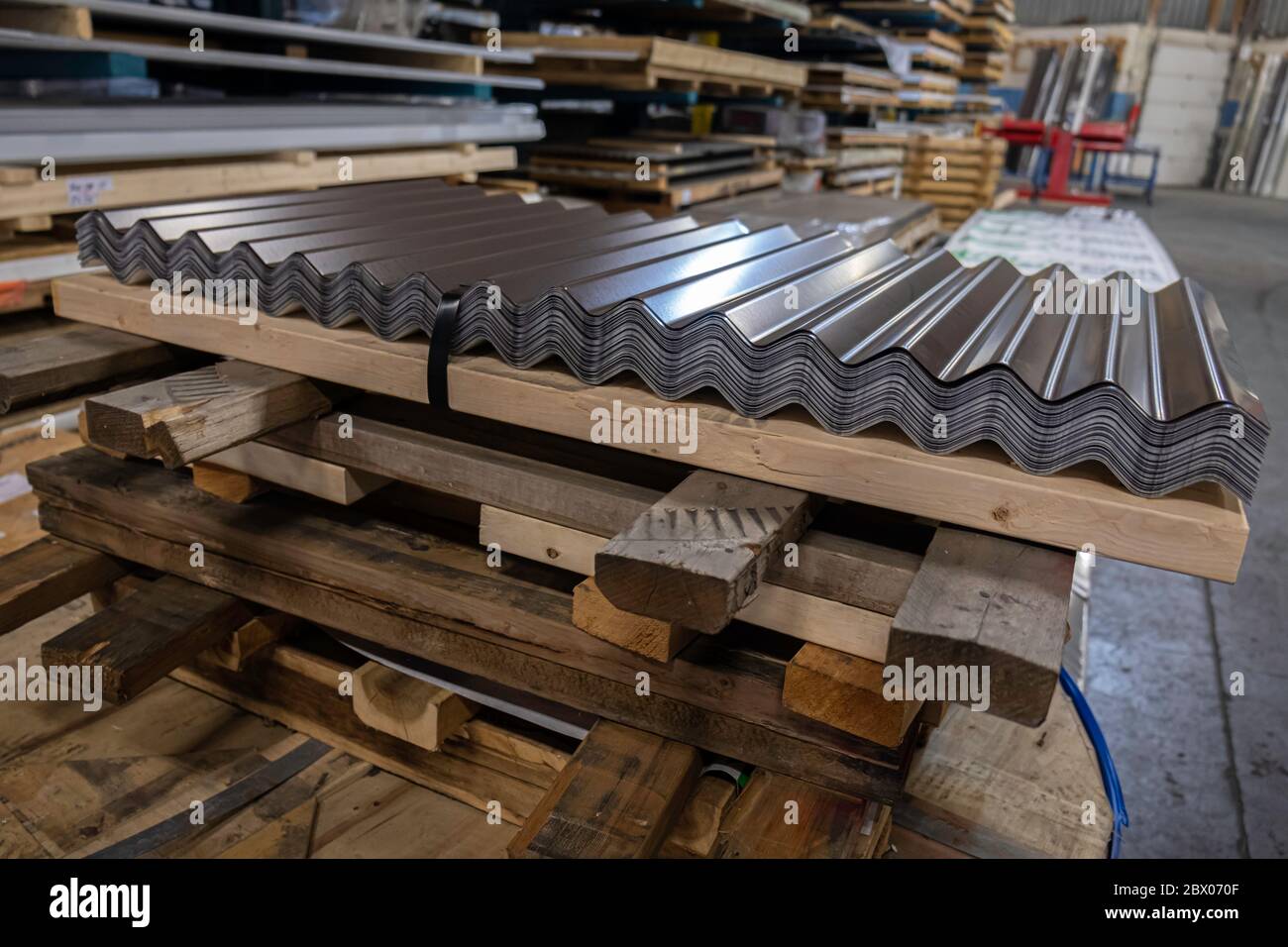 A stack of corrugated roofing sheets on wooden pallet for delivery ...