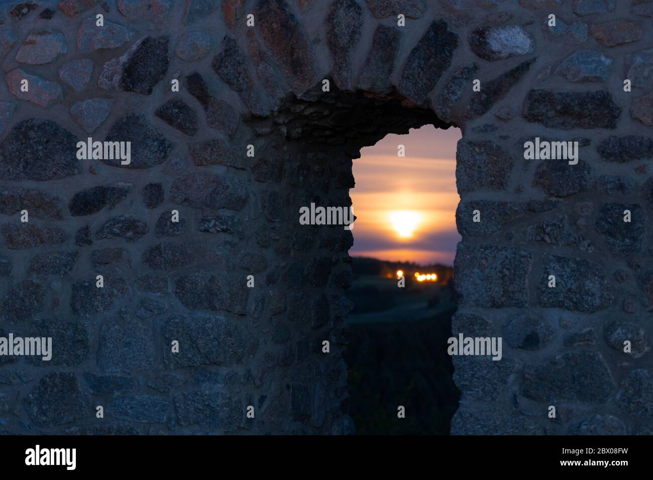 Looking through door in old stone brick wall of castle ruin with ...