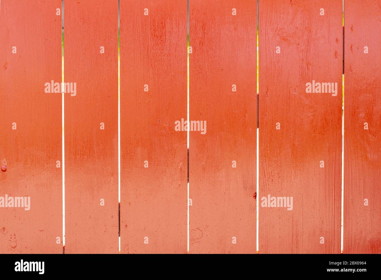 Freshly painted bright red pastel colored wooden fence Stock Photo - Alamy