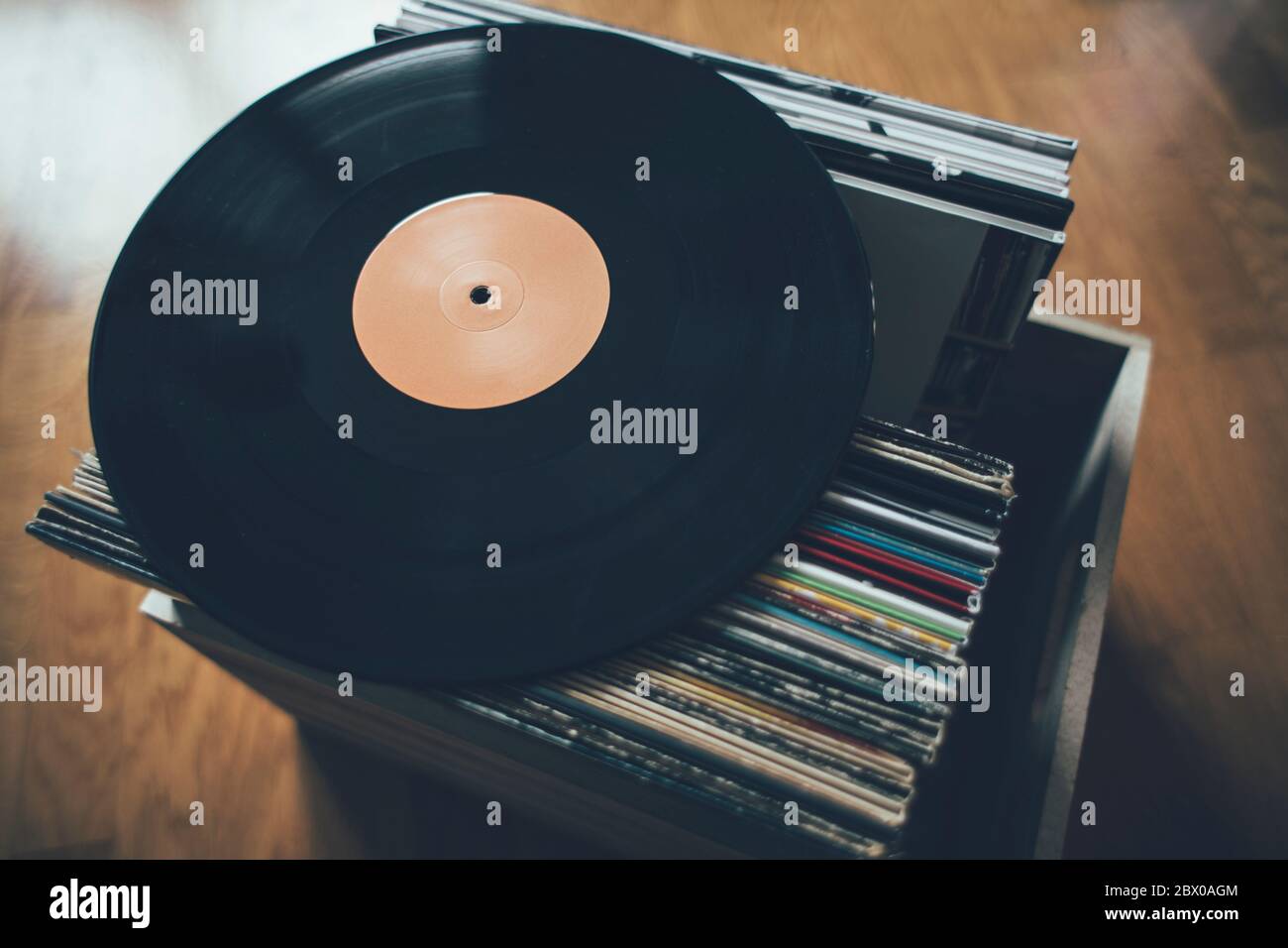 Vinyl record on stack of records collection Stock Photo - Alamy