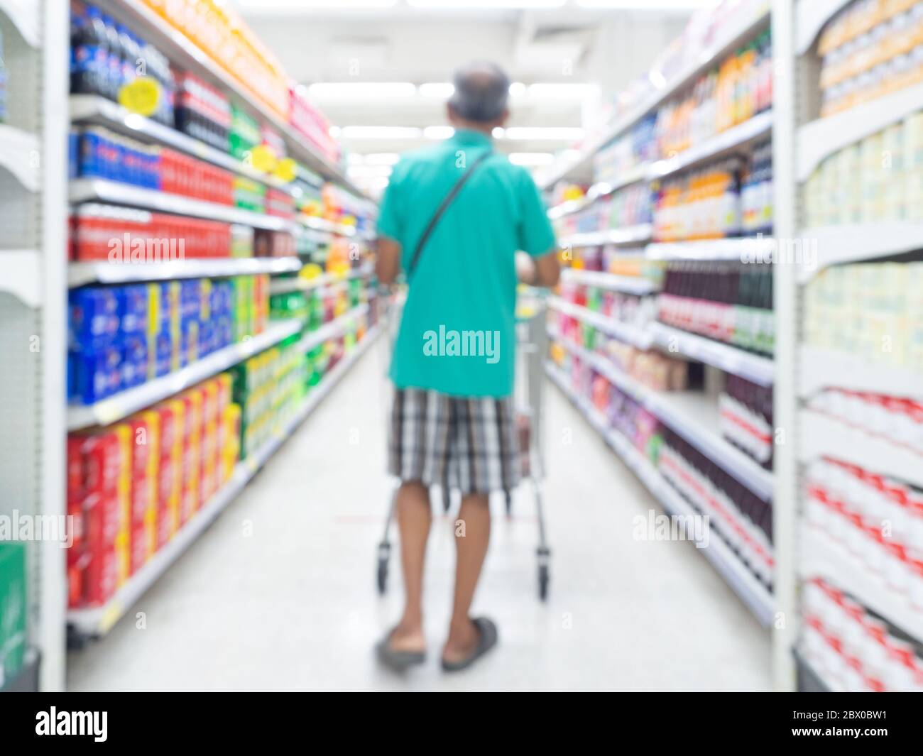 Supermarket blur background. Blurred interior view with shopping man on ...