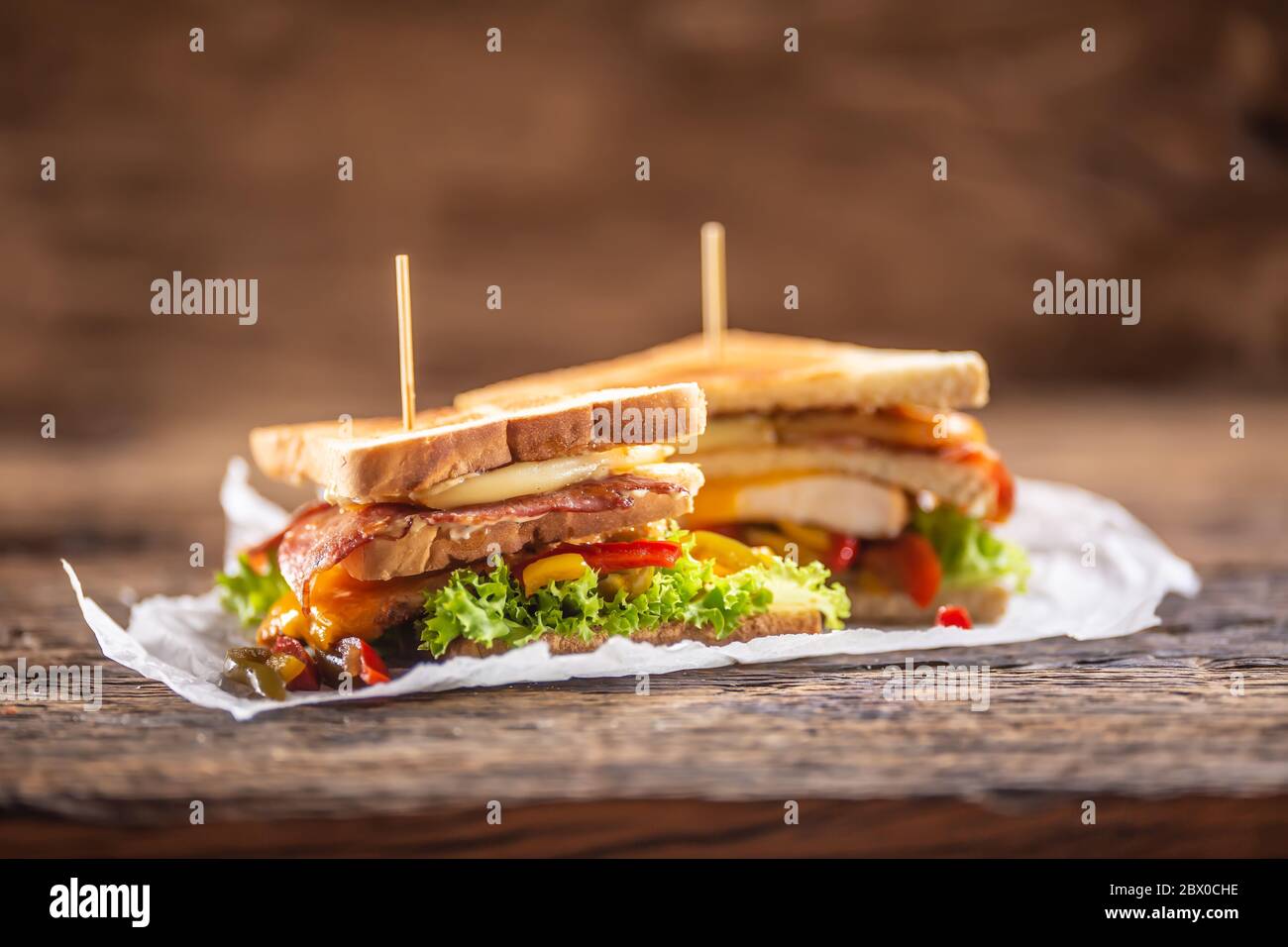 Club sandwich on a rustic table witch chicken, bacon and veg Stock ...