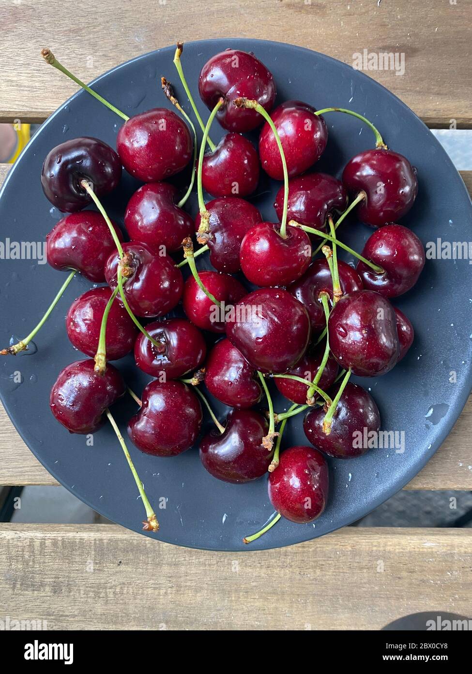Top view cherry in plate, closeup Stock Photo - Alamy